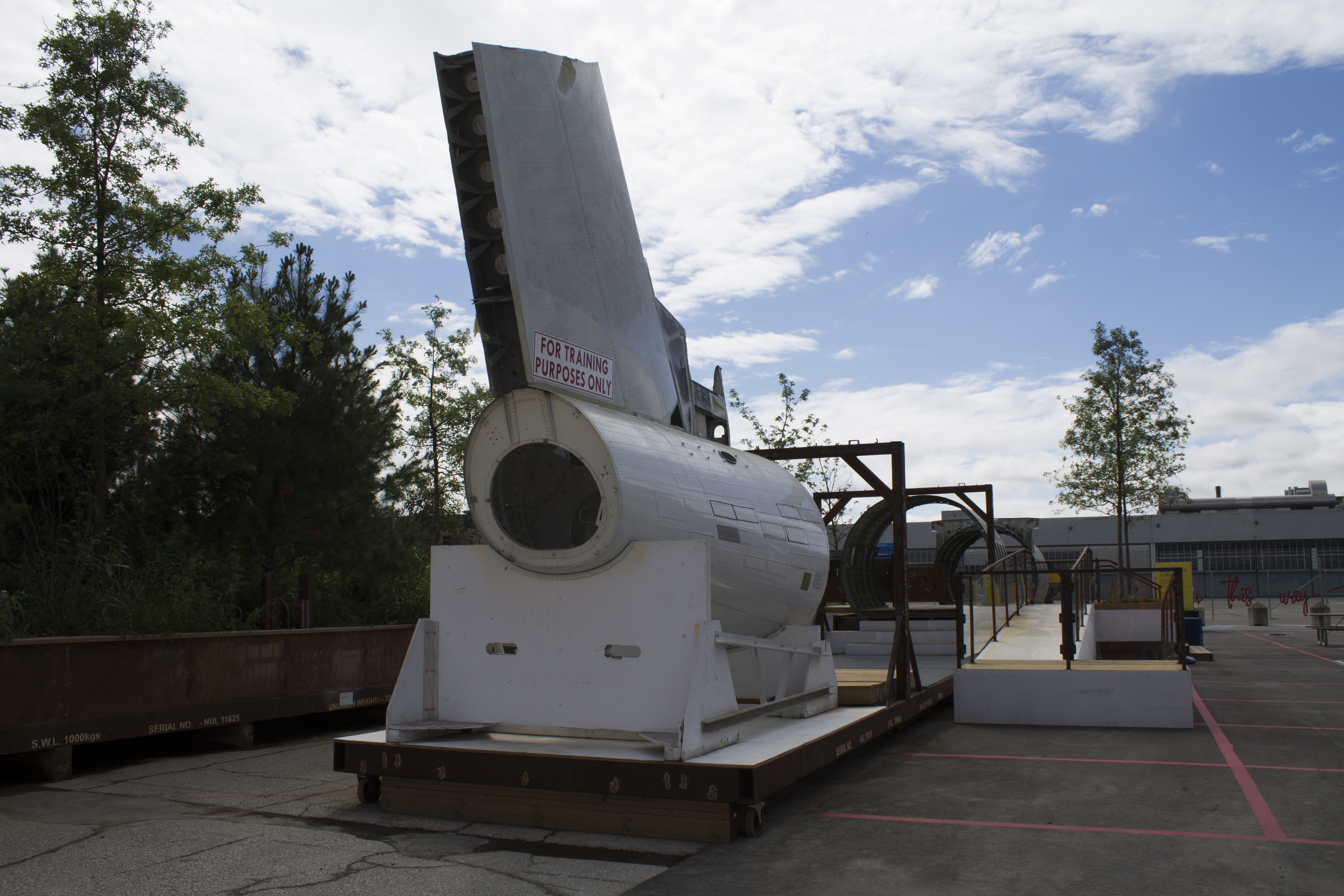 White Airplane Fuselage Rudder Outside the YZD Building by APlusDesign